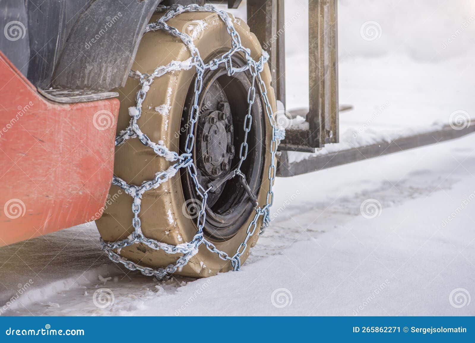 Cargo Loader in Winter on Snow. the Loader Ride on Snow with Chains on ...