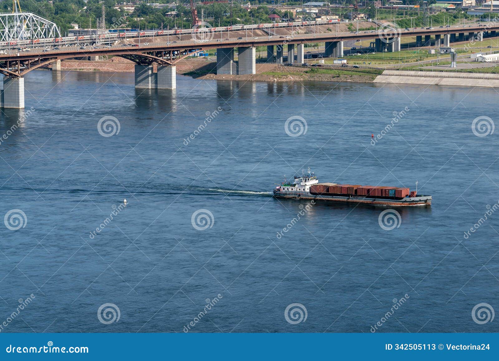 A Cargo Ship with Containers Sails Under a Bridge. River Transport ...