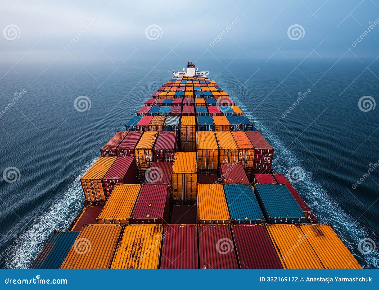 A Cargo Ship with Containers Stacked in Neat Rows Moves Along the Calm ...