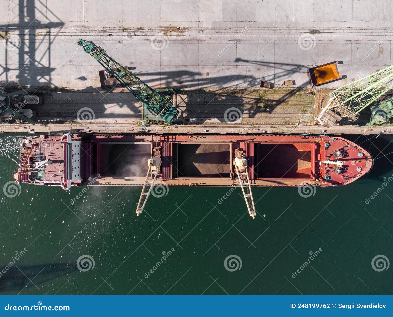 Cargo Ship Loading in Port at Sunset Stock Photo - Image of equipment ...