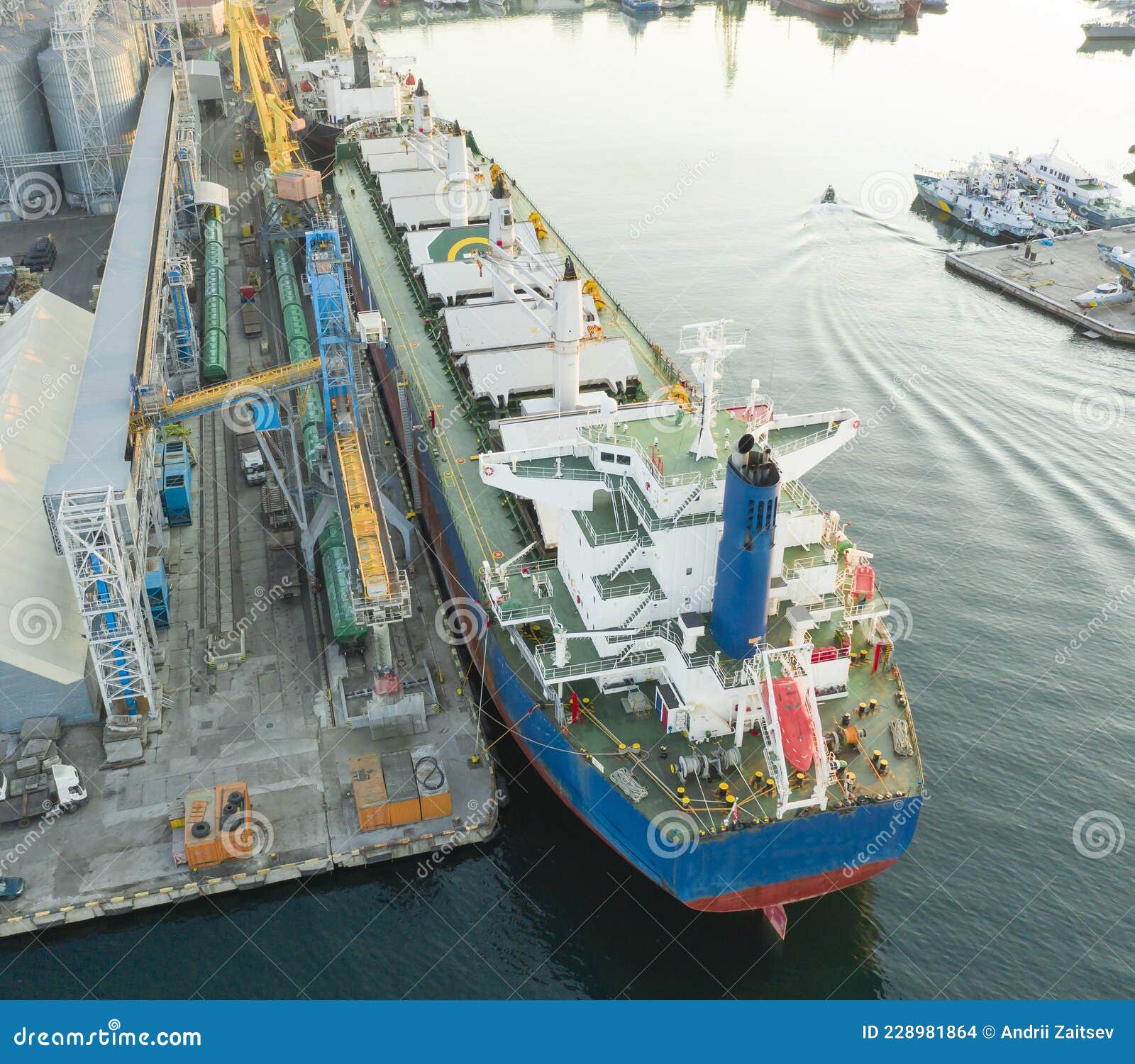 A Cargo Ship at the Pier in the Port. the Loading Process is in ...