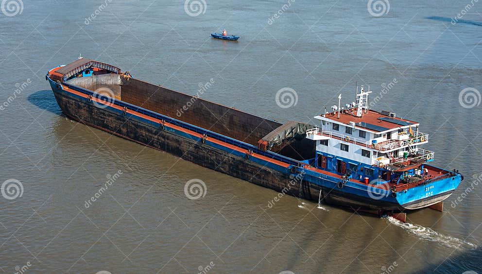 Cargo Ship on River with Small Boat Stock Image - Image of journey ...