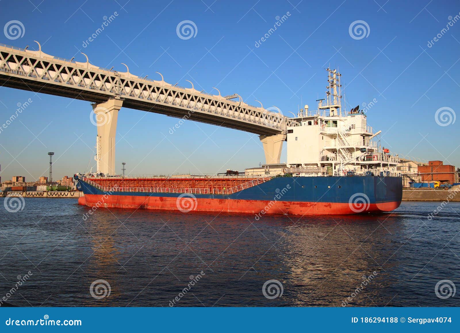 Cargo Ship Sailing Under a Bridge Stock Photo - Image of coast ...