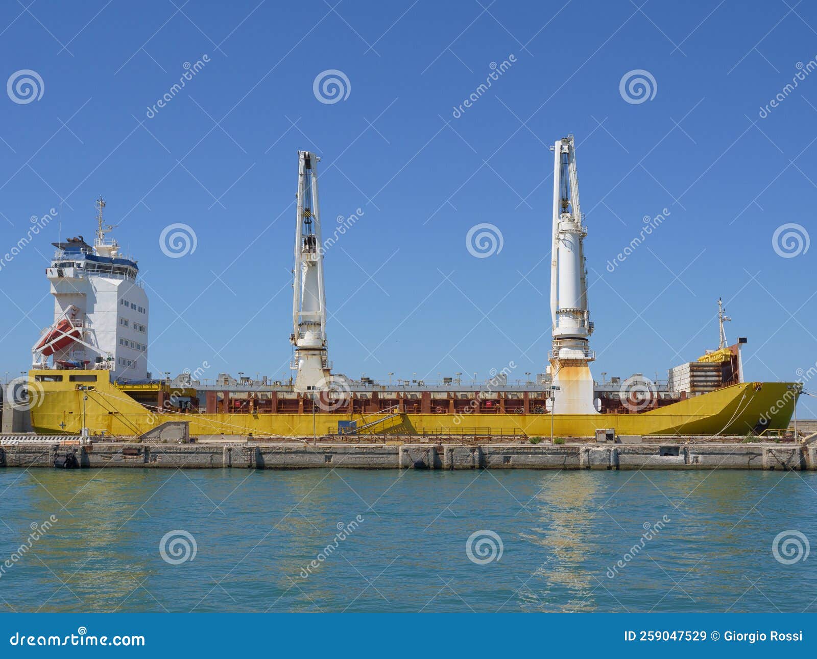 Cargo Ship Under Maintenance at a Shipyard with Two High Cranes Stock ...