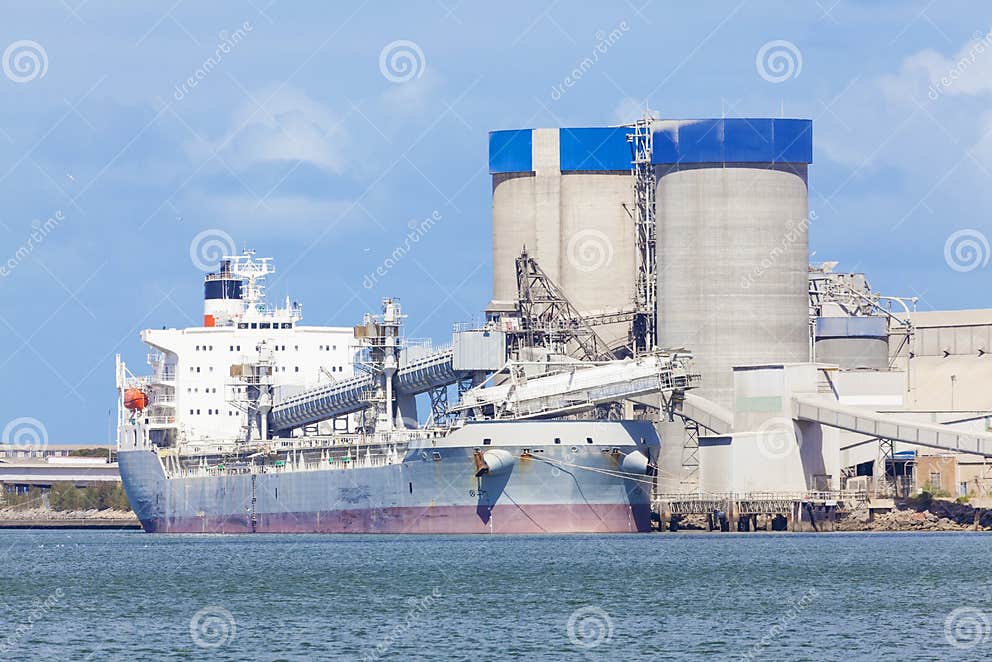 Cargo Ship Unloading at a Cement Plant Stock Photo - Image of loading ...