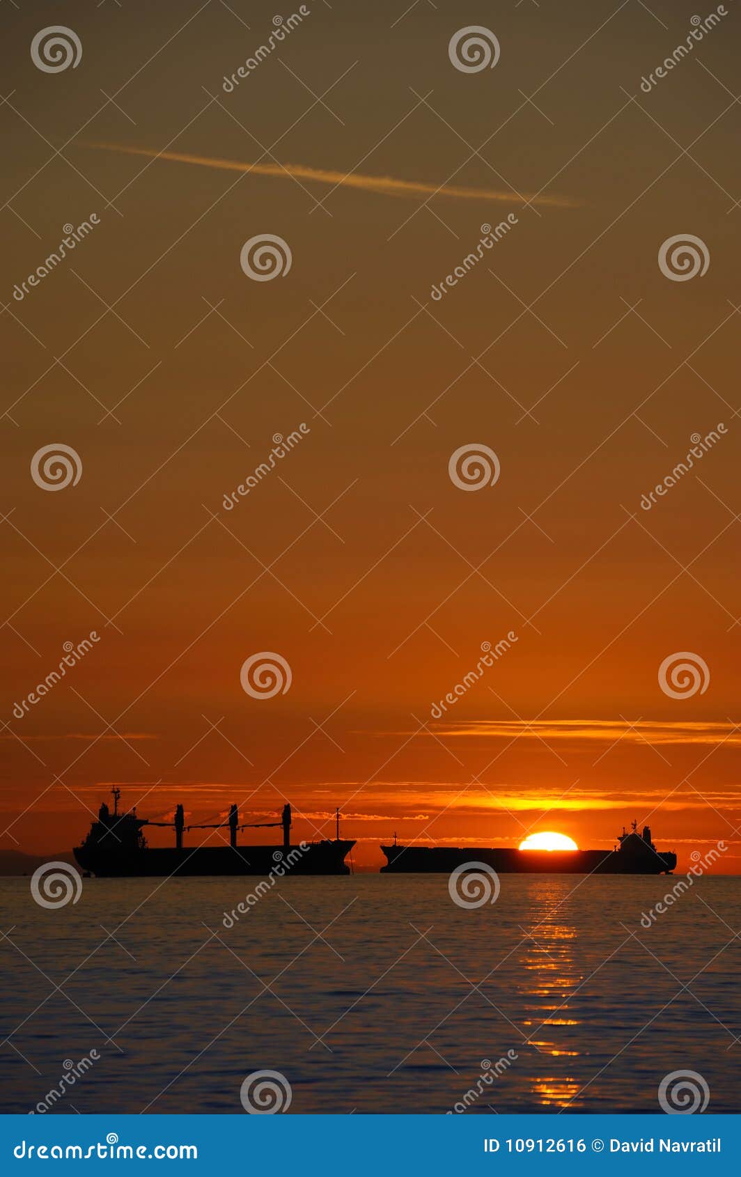 Cargo ships at sunset stock photo. Image of industry - 10912616