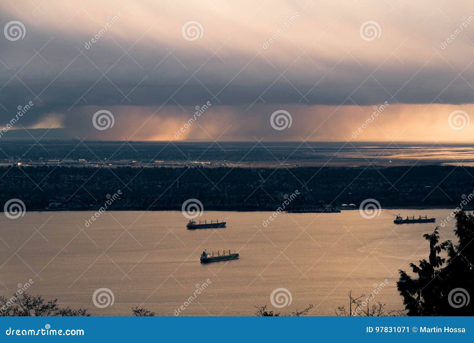 Cargo Ships on Water with Rainy Clouds in the Background Stock Image ...