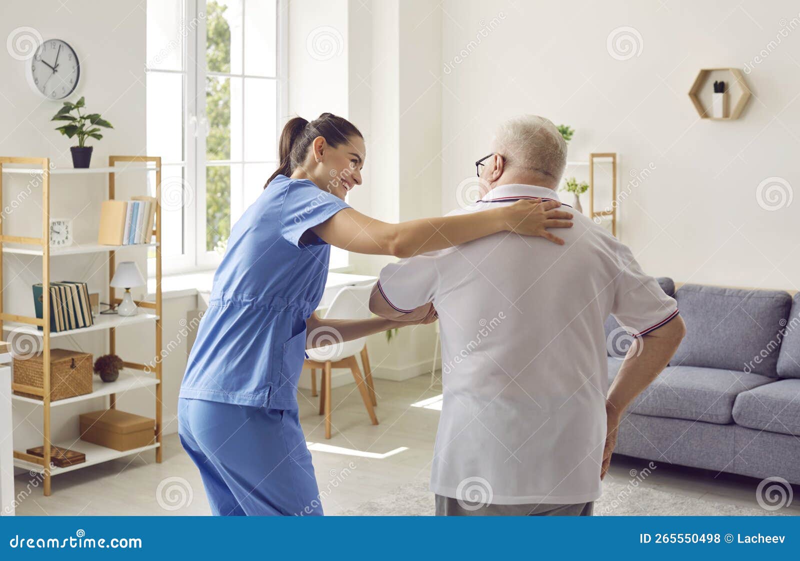 Caring Caregiver Woman Assisting Her Disabled Elderly Patient Stock