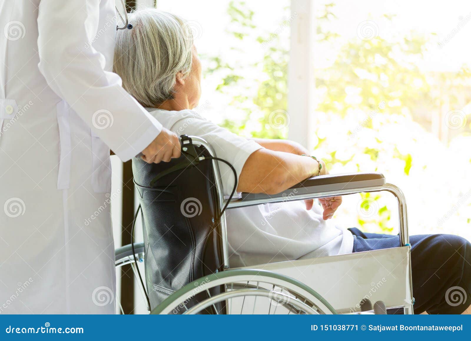 Caring Doctor Or Nurse Supporting Disabled Alzheimer Senior Asian Woman