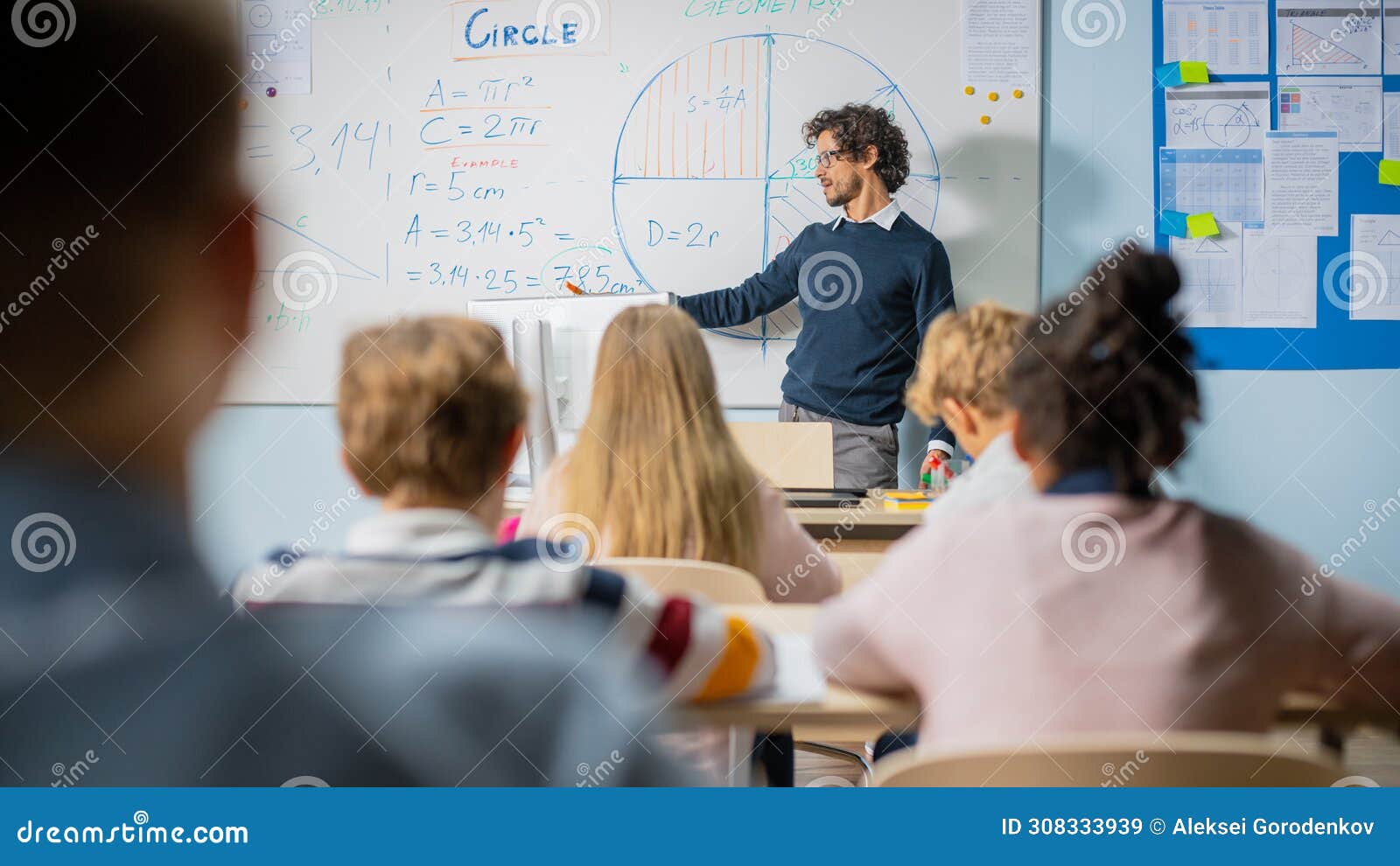 Caring Teacher Explains Lesson To a Classroom Full of Bright Diverse ...