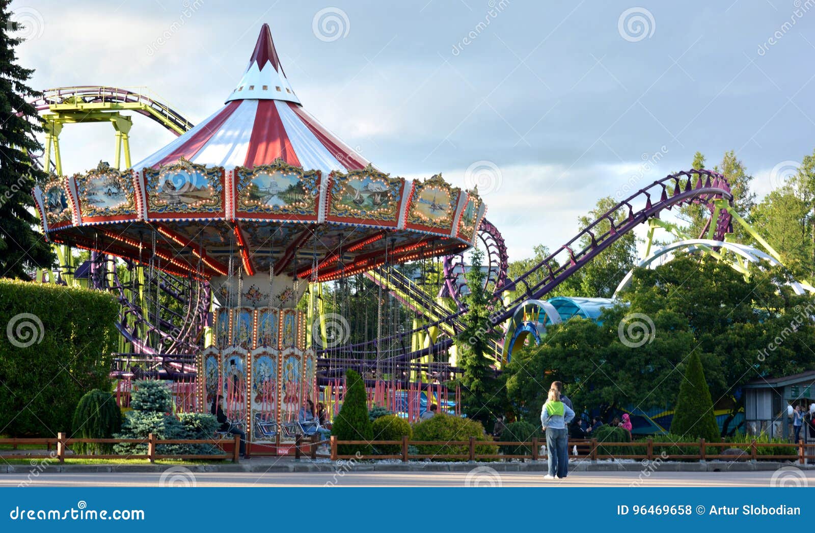 Carousel and Roller Coaster in an Amusement Park Editorial Stock Photo ...
