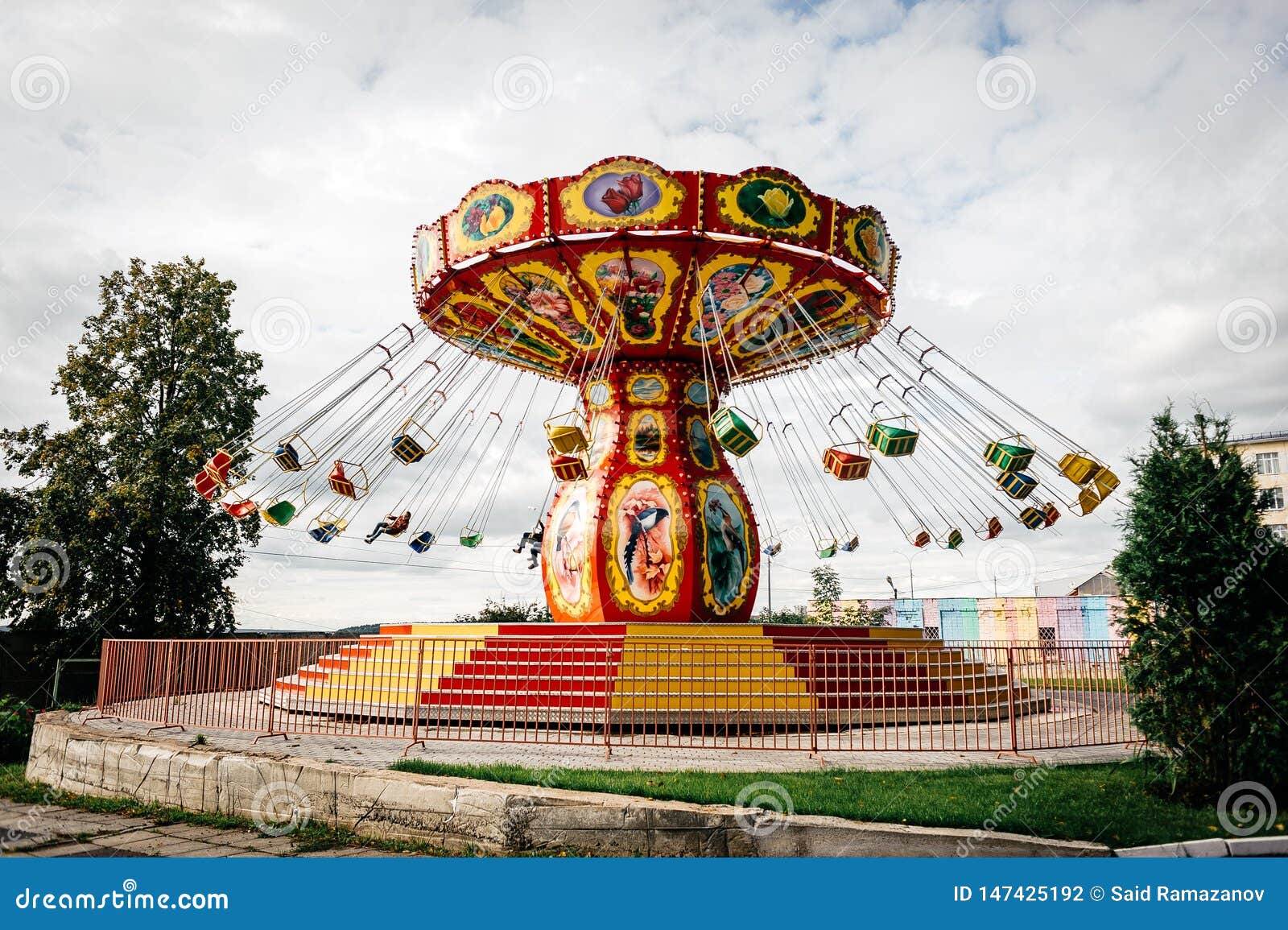 Carousel Whirlwind in the Park Against a Cloudy Sky Stock Photo - Image ...