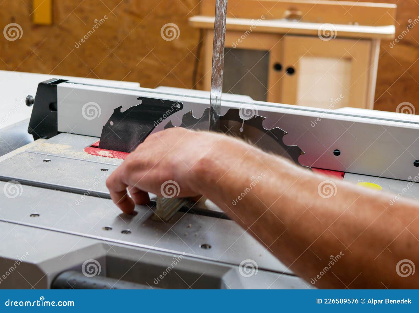 Carpenter Adjusting the Blade Using a Right Angle Square at the Table ...