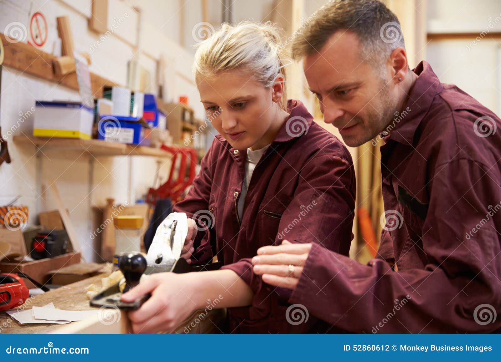 Carpenter with Apprentice Planing Wood in Workshop Stock Photo - Image ...