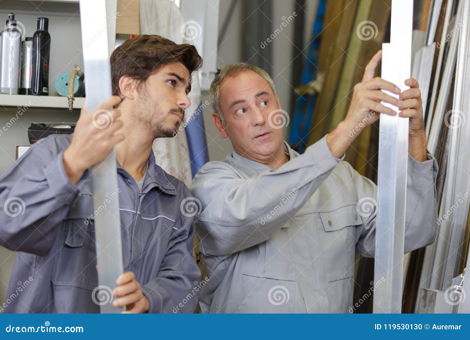 Carpenter with Apprentice in Workshop Stock Photo - Image of protection ...