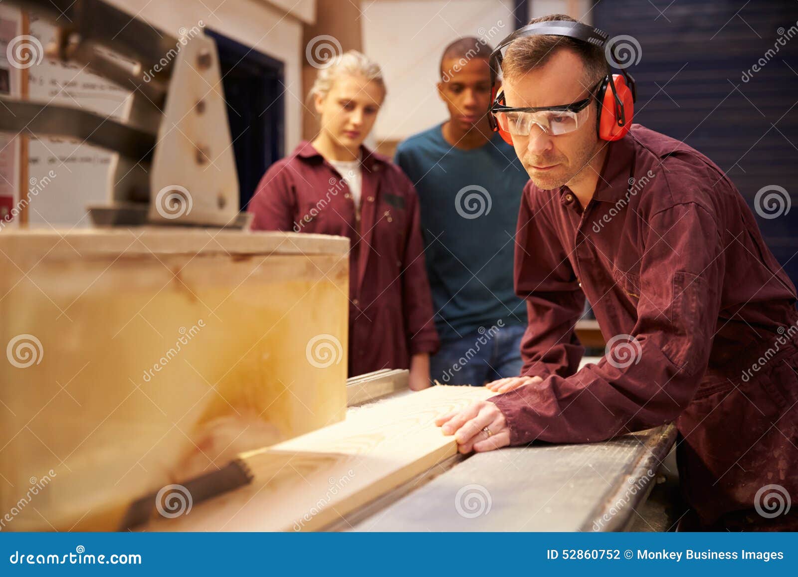 Carpenter with Apprentices Using Circular Saw in Workshop Stock Photo ...