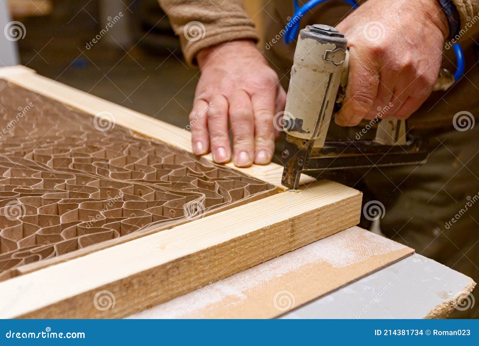 Carpenter Assembles Boards on the Door Frame with Pneumatic Stapler ...