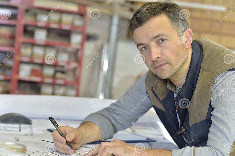 Carpenter designing plans stock image. Image of table - 49776119