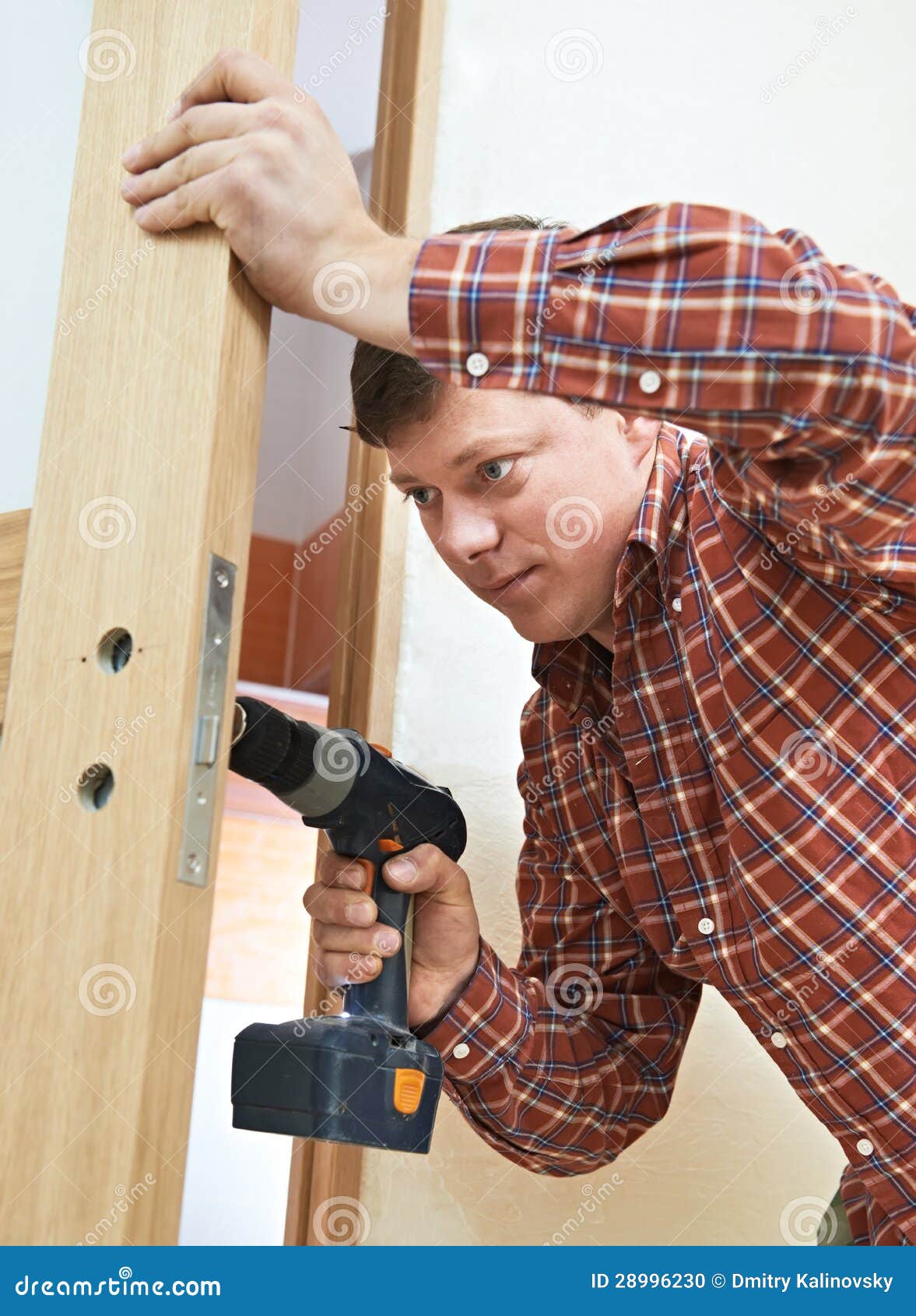 Carpenter at Door Lock Installation Stock Photo - Image of construction ...