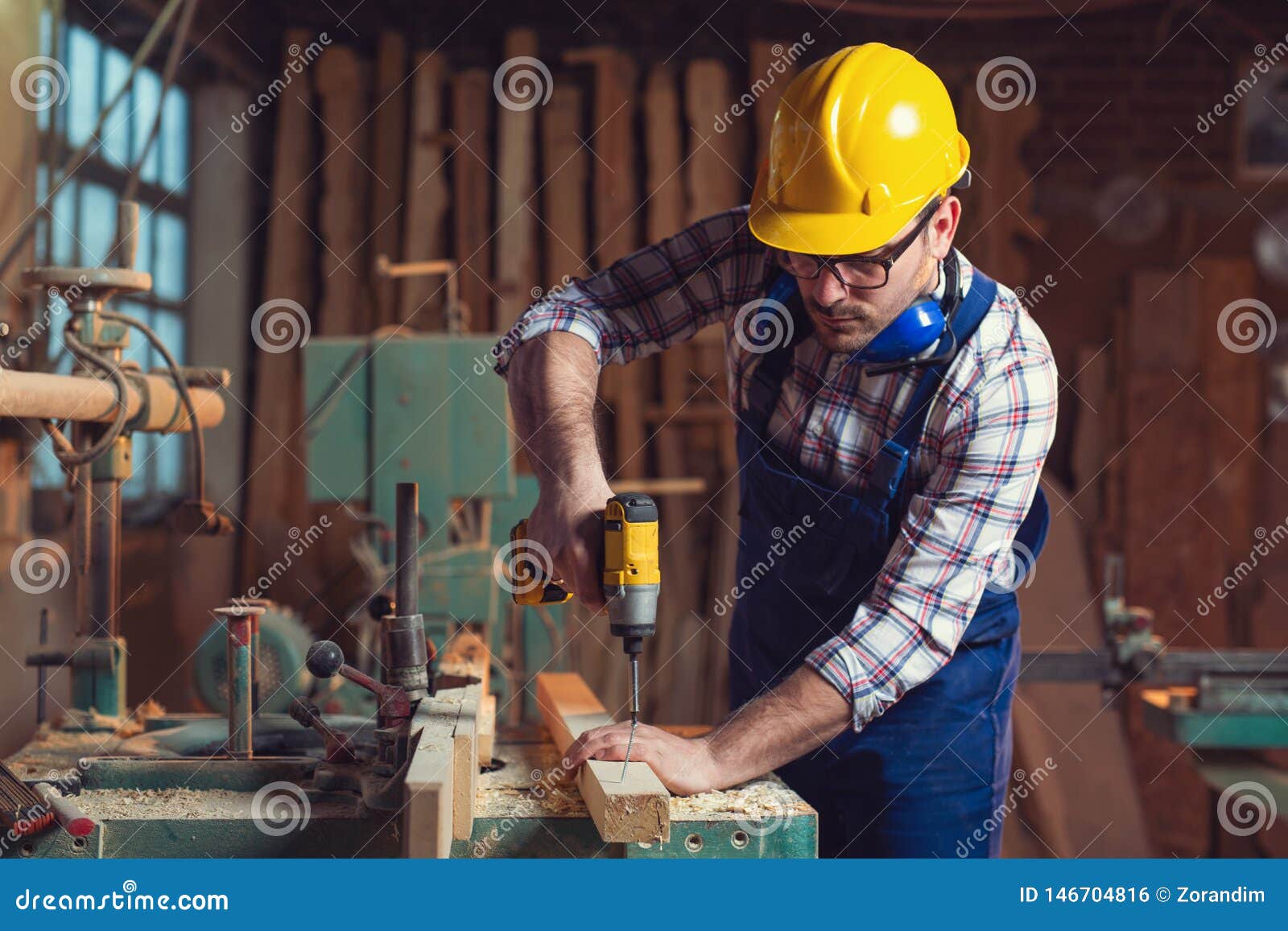 Carpenter Drilling a Hole in Wooden Plank on Workbench. Stock Photo ...