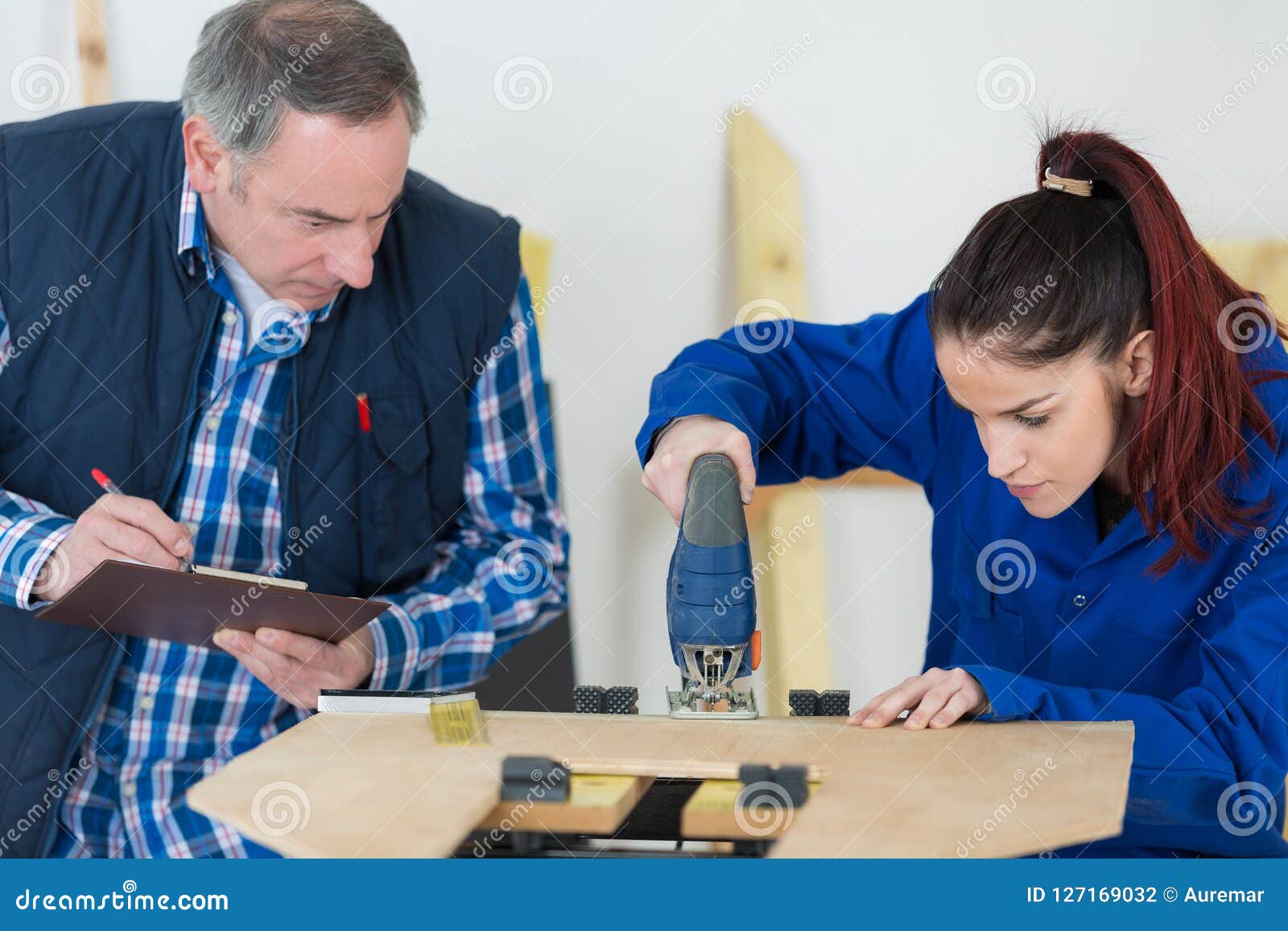 Carpenter with Female Apprentice Working on Building Site Stock Photo ...