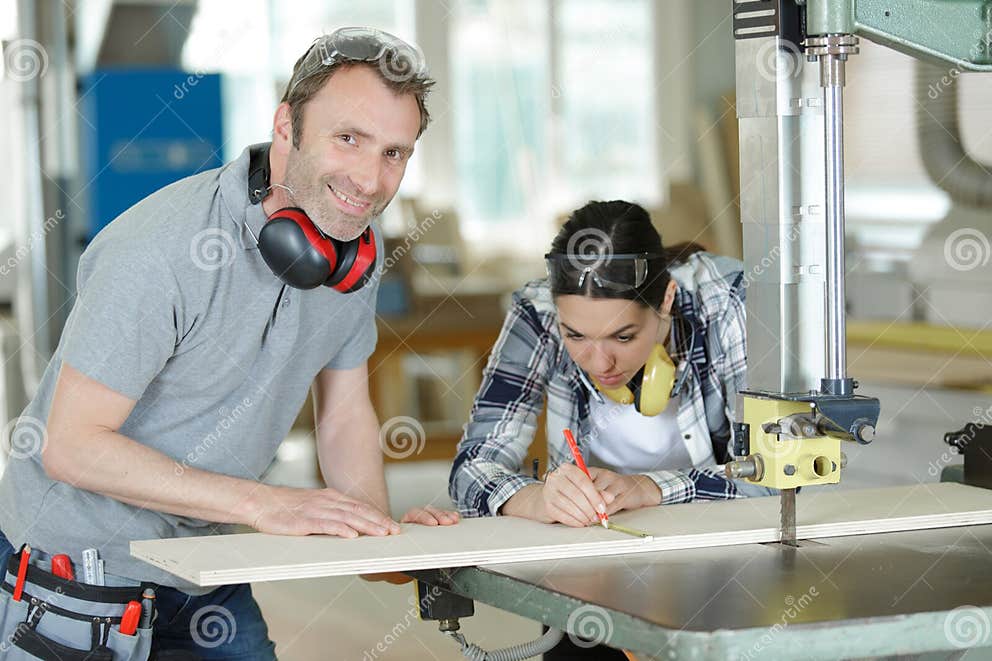 Carpenter with Female Apprentice Working on Building Site Stock Image ...