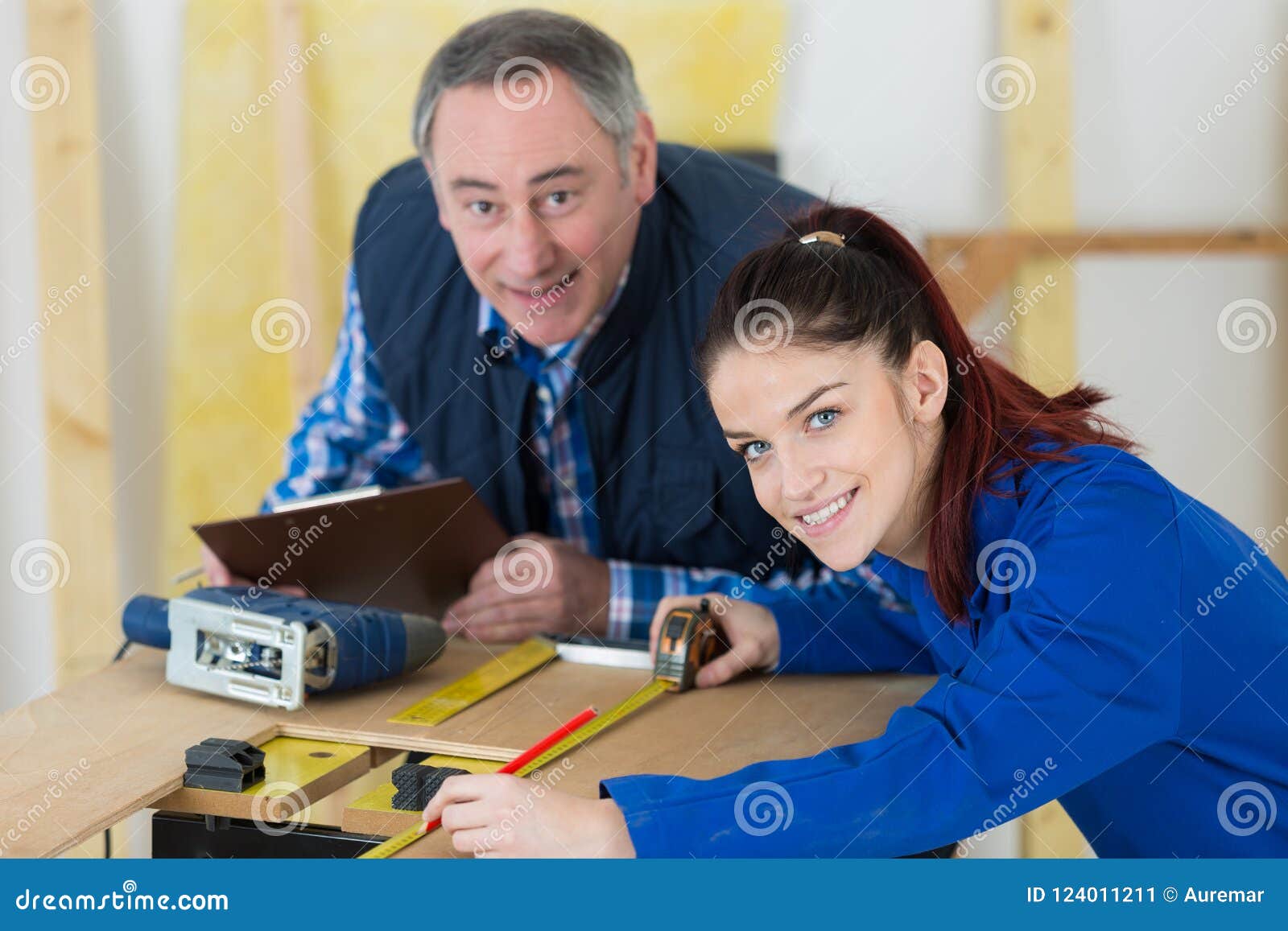 Carpenter with Female Apprentice Working on Building Site Stock Image ...