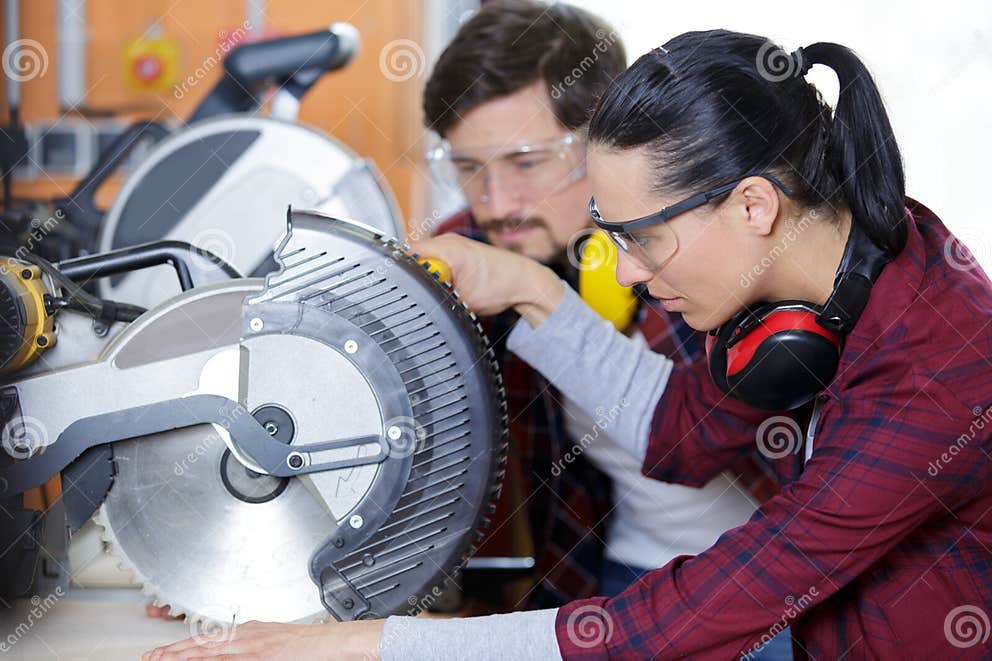 Carpenter and Female Apprentice Working Together in Workshop Stock ...