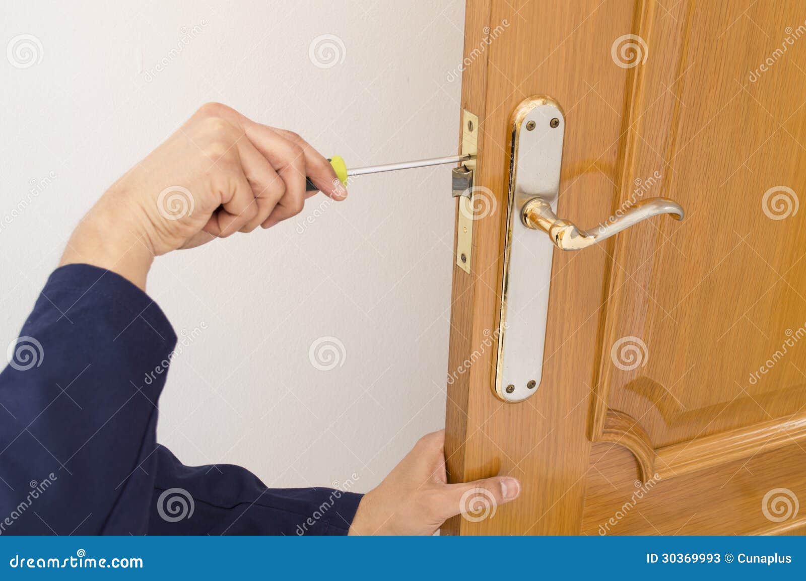 Carpenter Fixing a Lock in the Door with a Screwd Stock Image - Image ...