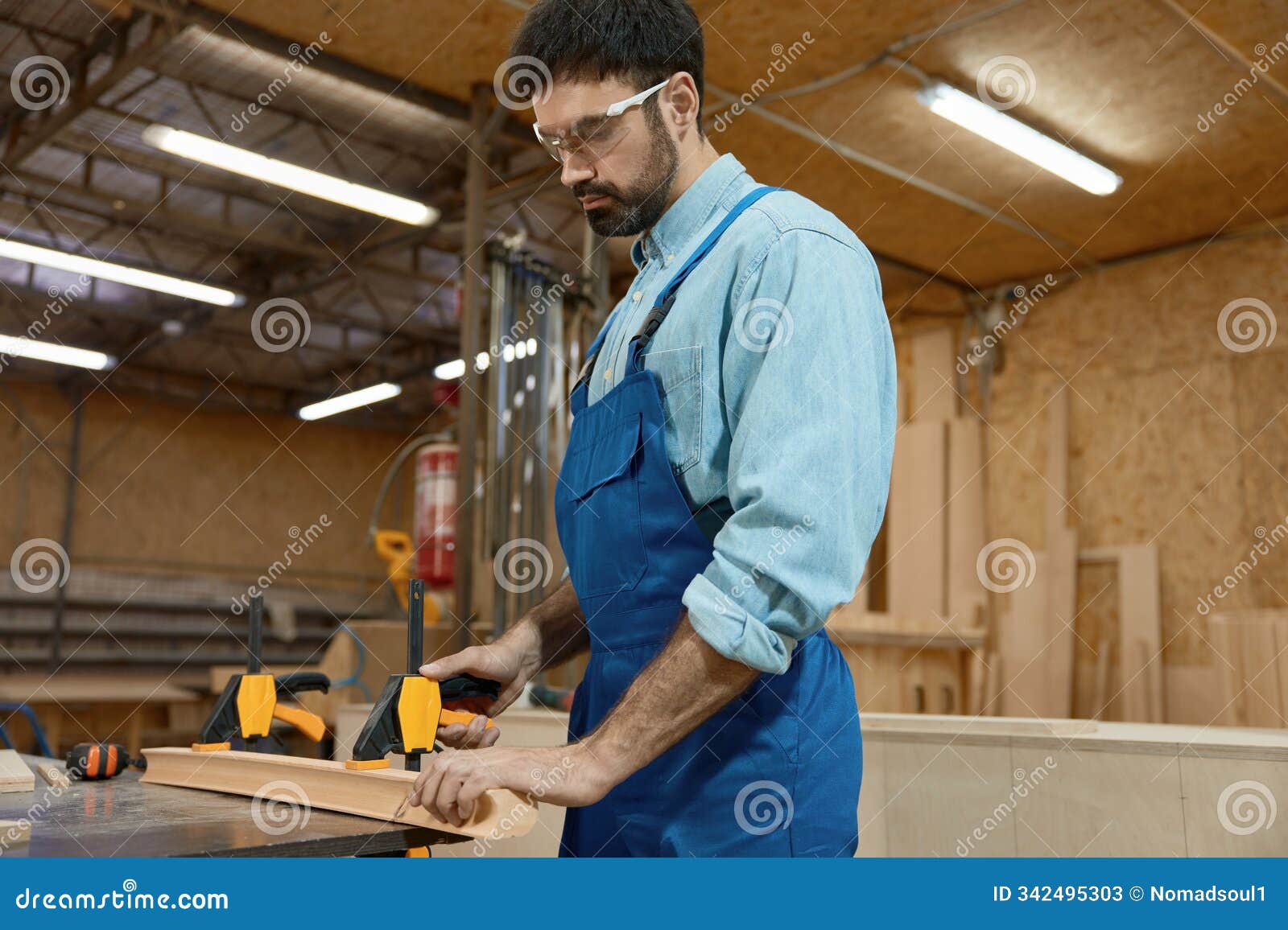 Carpenter Fixing Wooden Plank on Workbench with Clamps at Craft ...