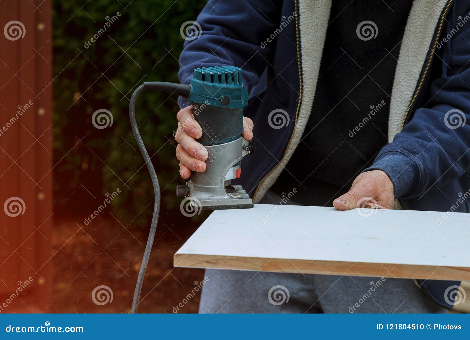 Hands of Carpenter with Electronic Plunge Router in the Hands on the ...