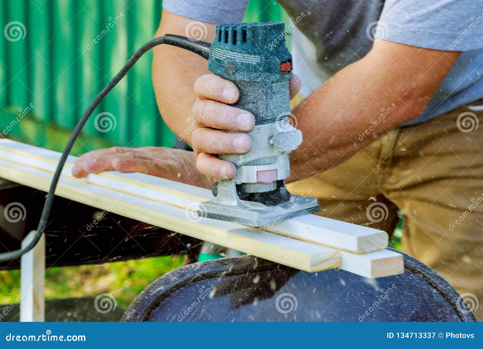 Hands of Carpenter with Electronic Plunge Router in the Hands on the ...