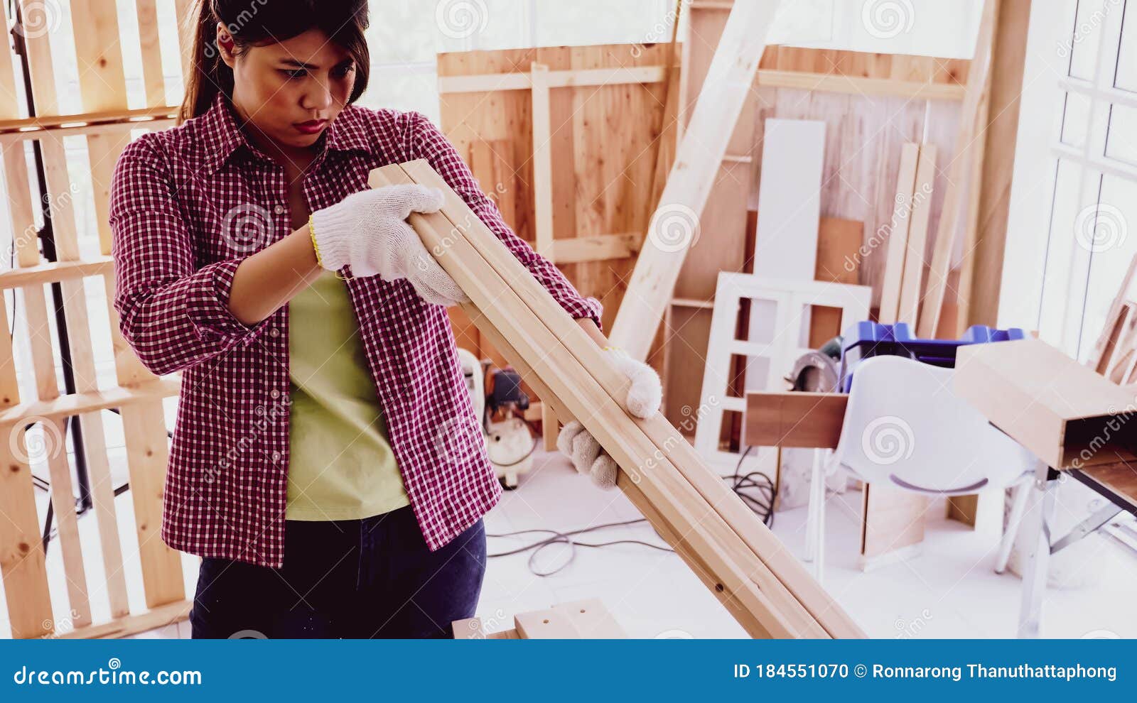 Carpenter Holding and Comparing Size of Pieces of Boards at Site Stock ...