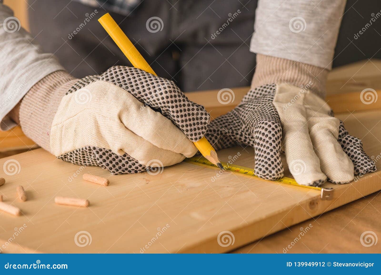 Carpenter Marking Straight Line On Plywood Sheet Using Spirit Level In ...