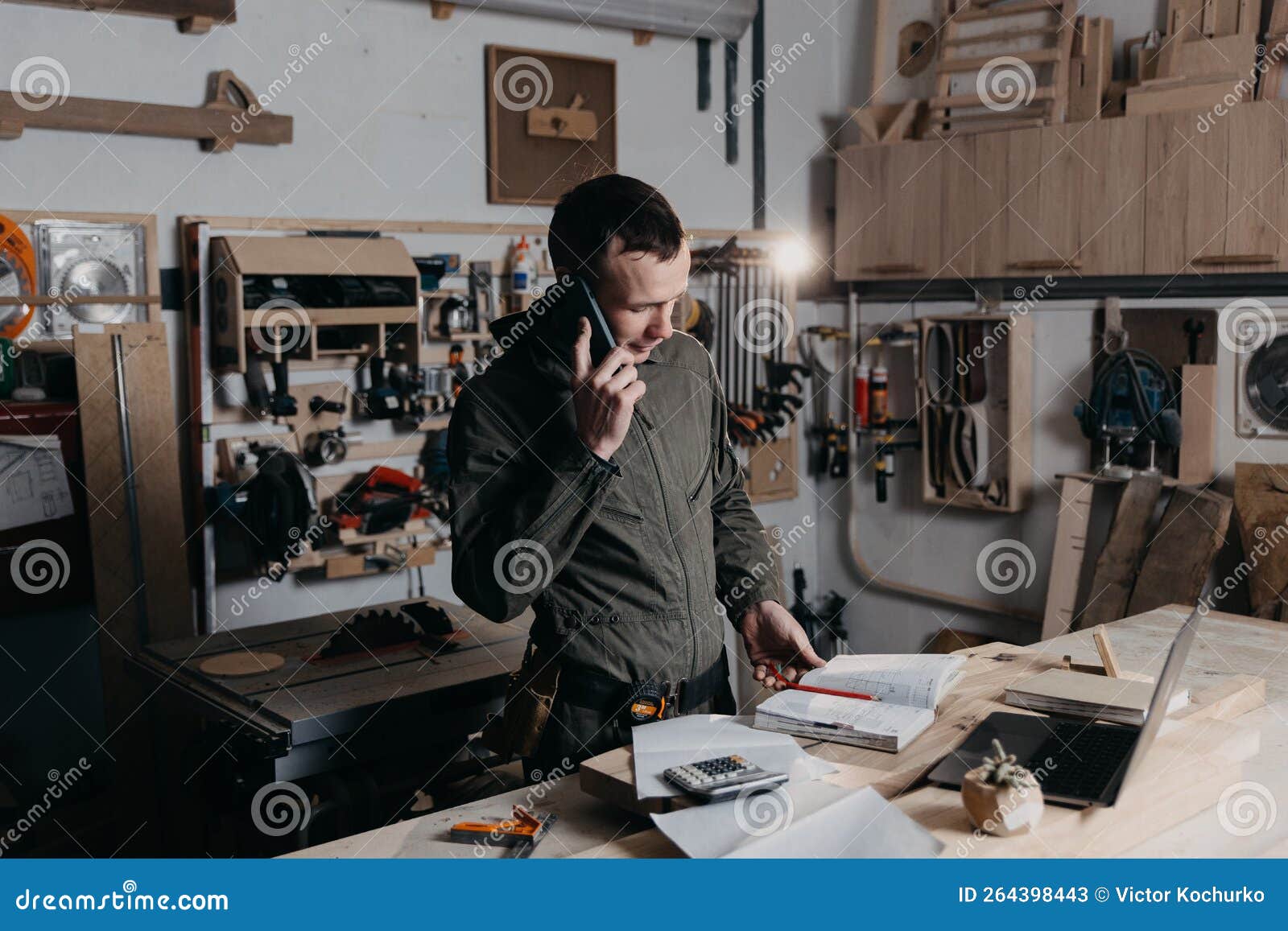 Carpenter Master is Phoning with the Smartphone in His Carpentry ...
