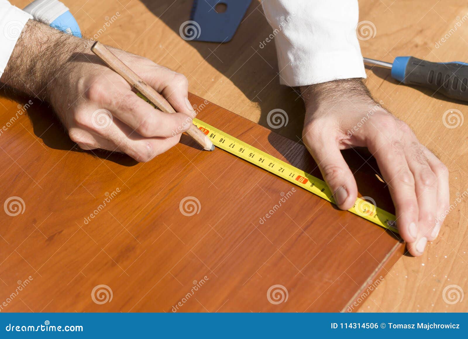 Carpenter Measures the Distance Using a Measure and Marks with a ...