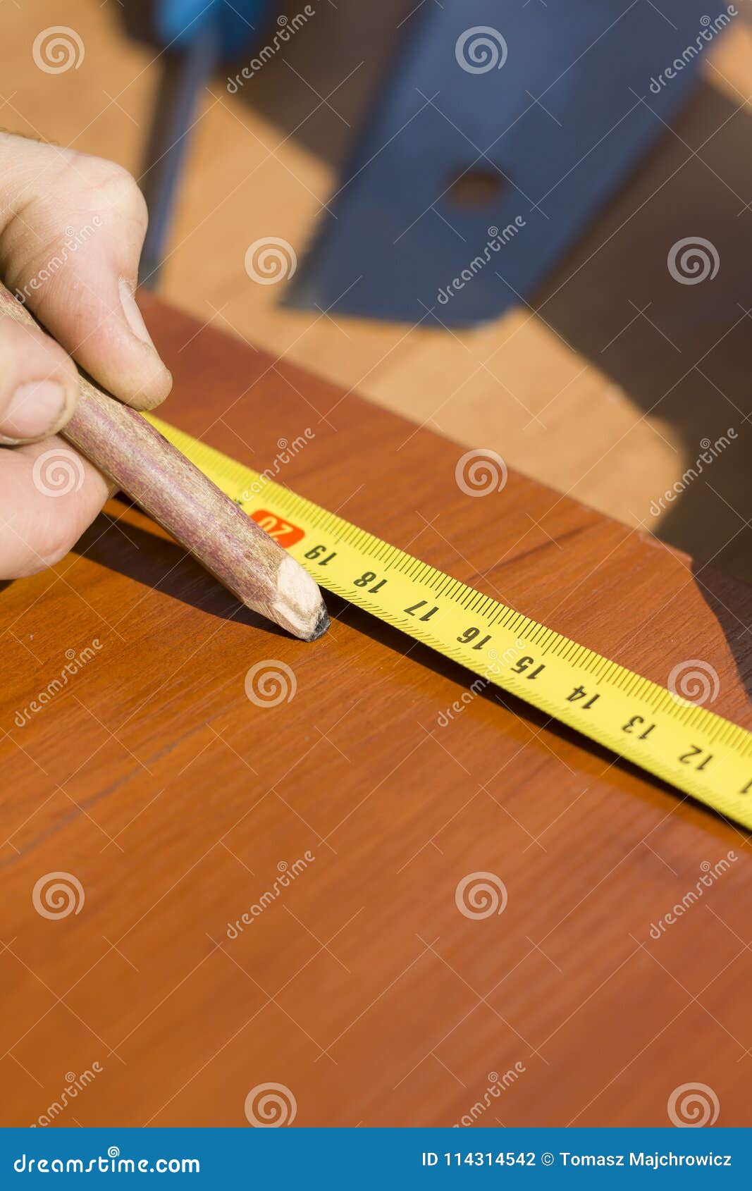 The Carpenter Measures the Distance Using a Measure and Marks with a ...