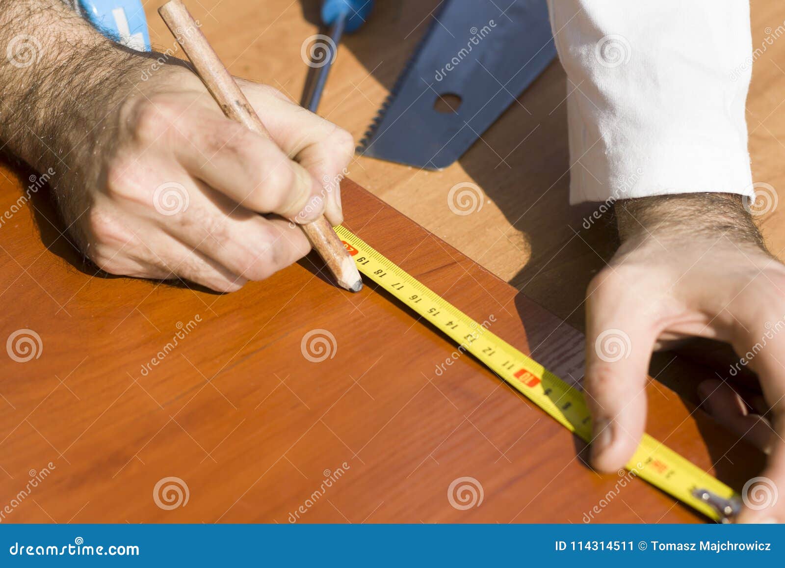 Carpenter Measures the Distance Using a Measure and Marks with a ...