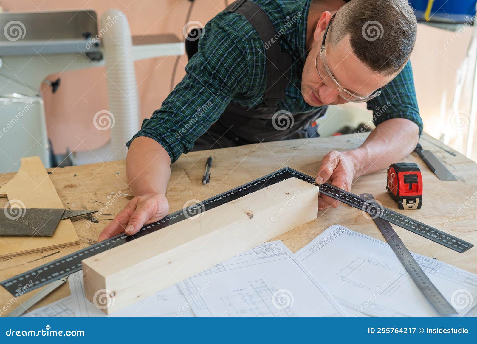 Carpenter Measures Wooden Planks in the Workshop. Stock Image - Image ...