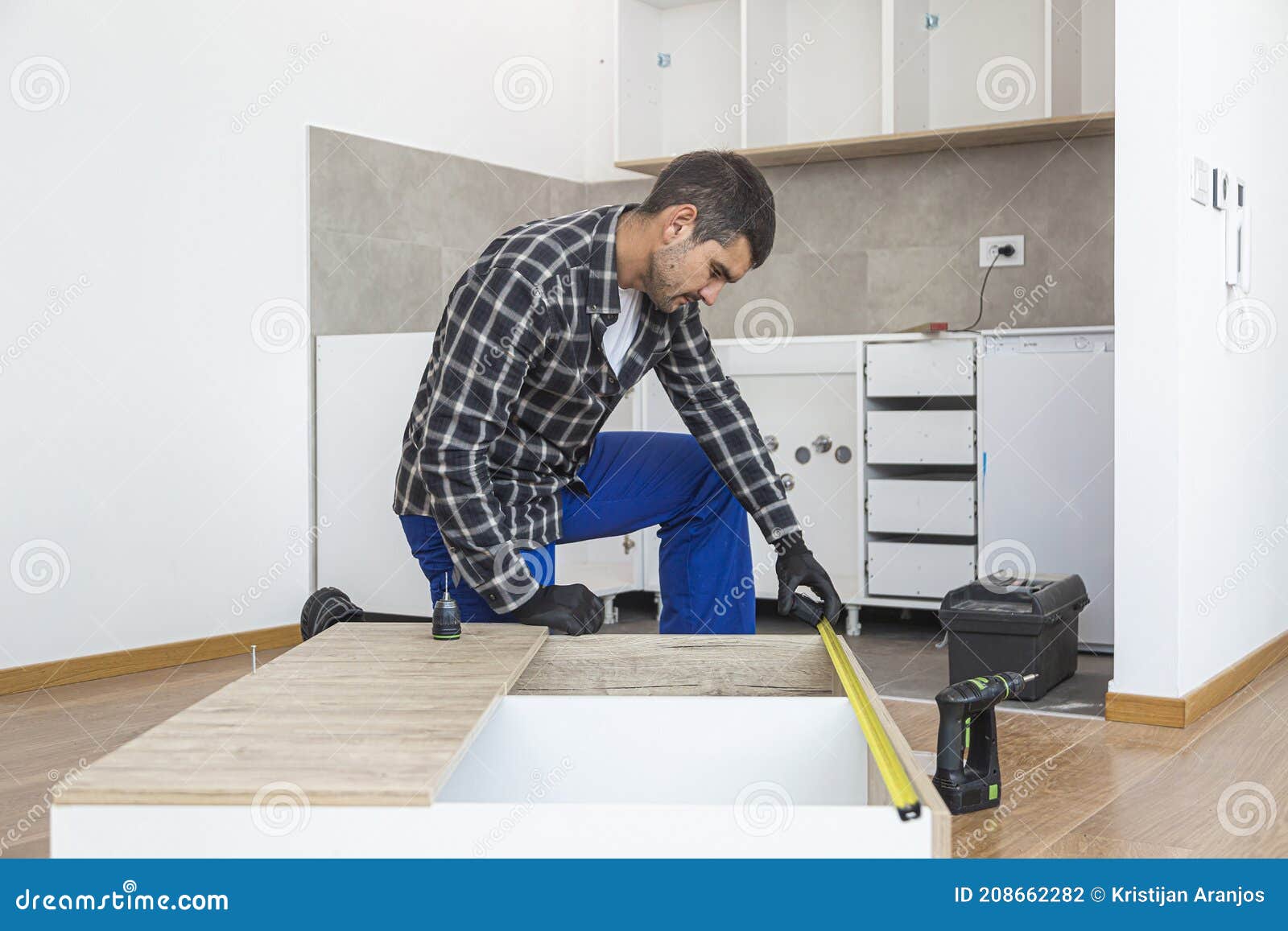 Carpenter Measuring Shelves that are Parts of New Kitchen with Meter ...