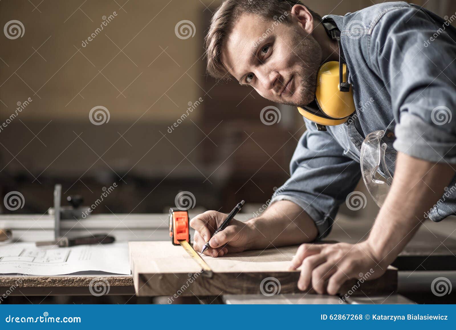Carpenter Measuring Wooden Board Stock Photo - Image of handsome ...