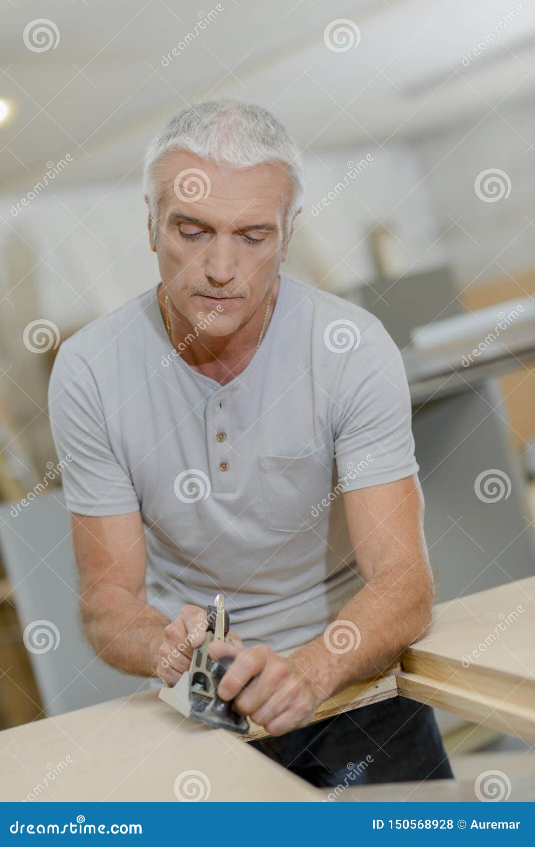 Carpenter planing wood stock photo. Image of making - 150568928