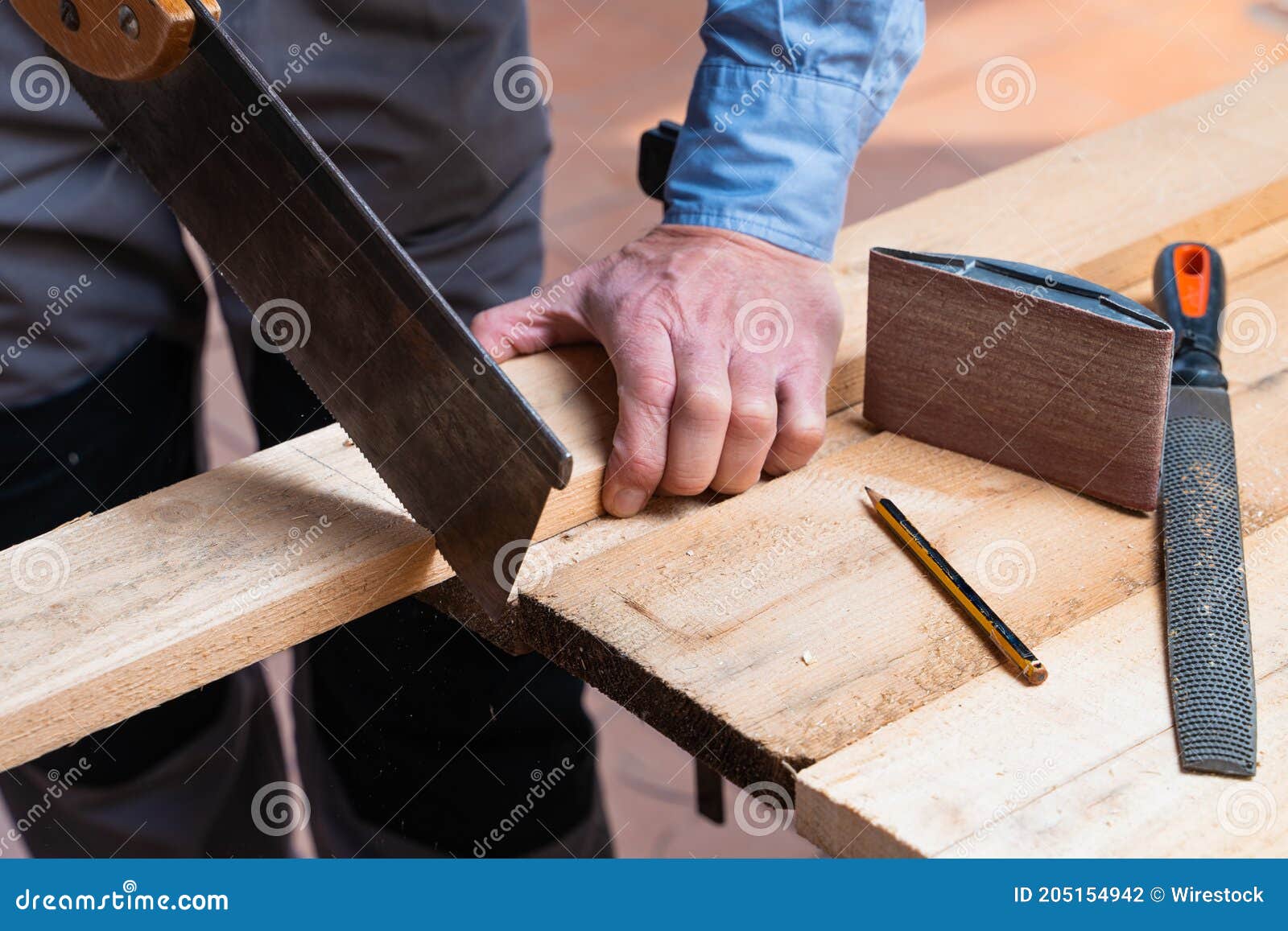 Carpenter in the Process of Cutting and Making Something from Wood ...