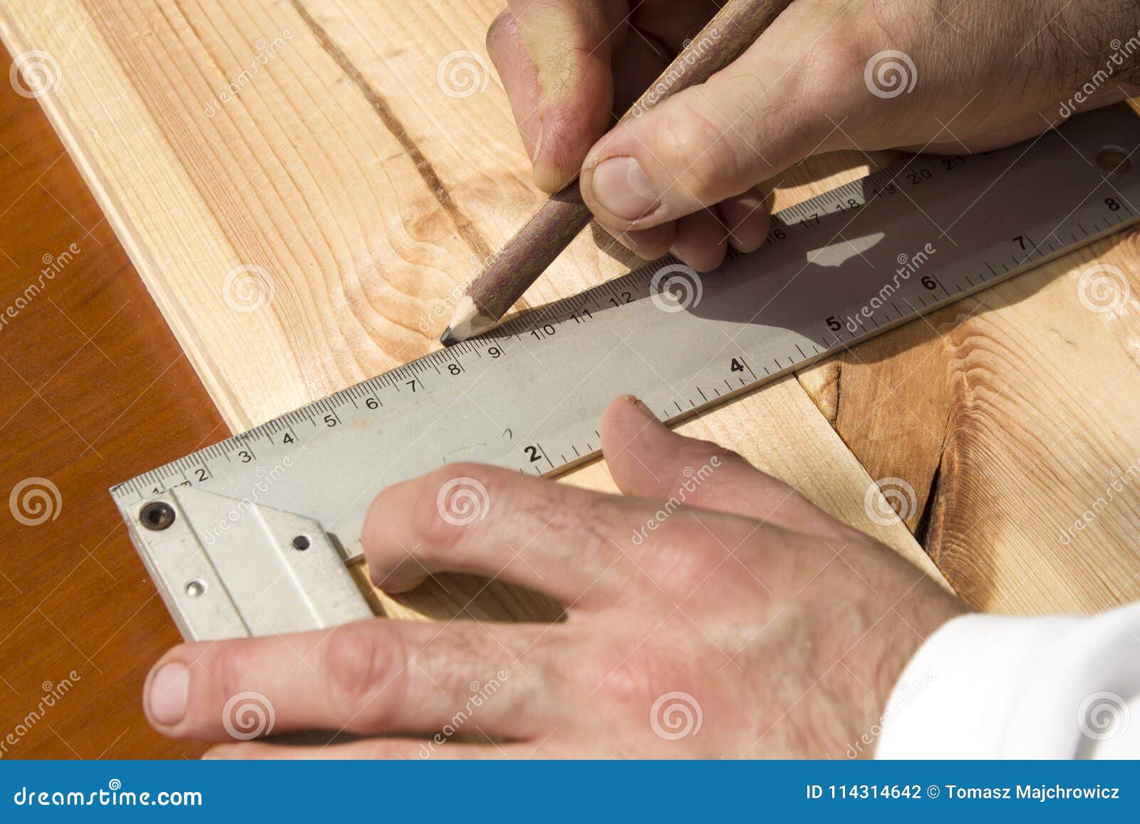 Carpenter`s Hands Indicate the Dimension on the Board with a Pencil and ...