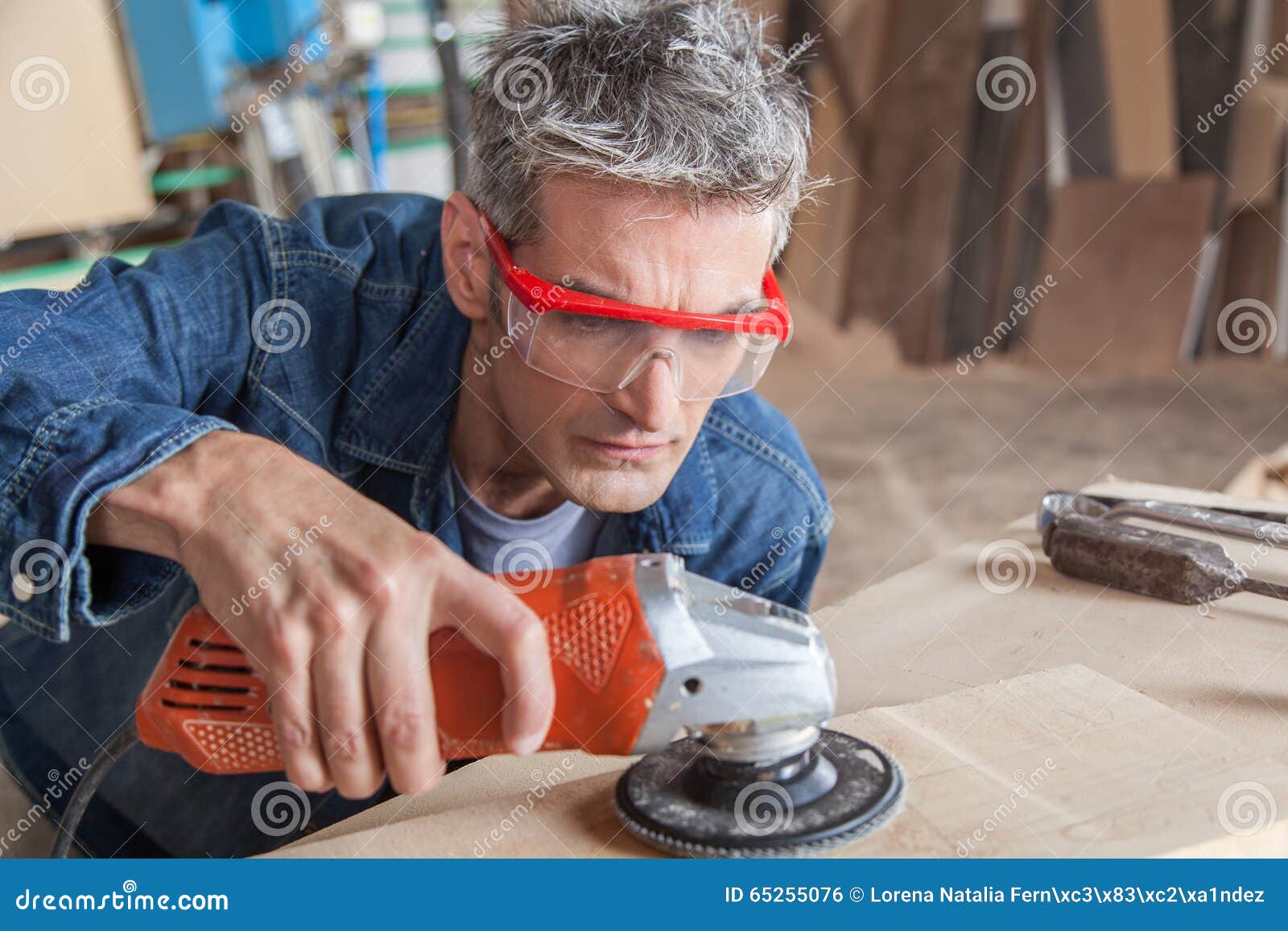 Carpenter with a sander stock photo. Image of machine - 65255076