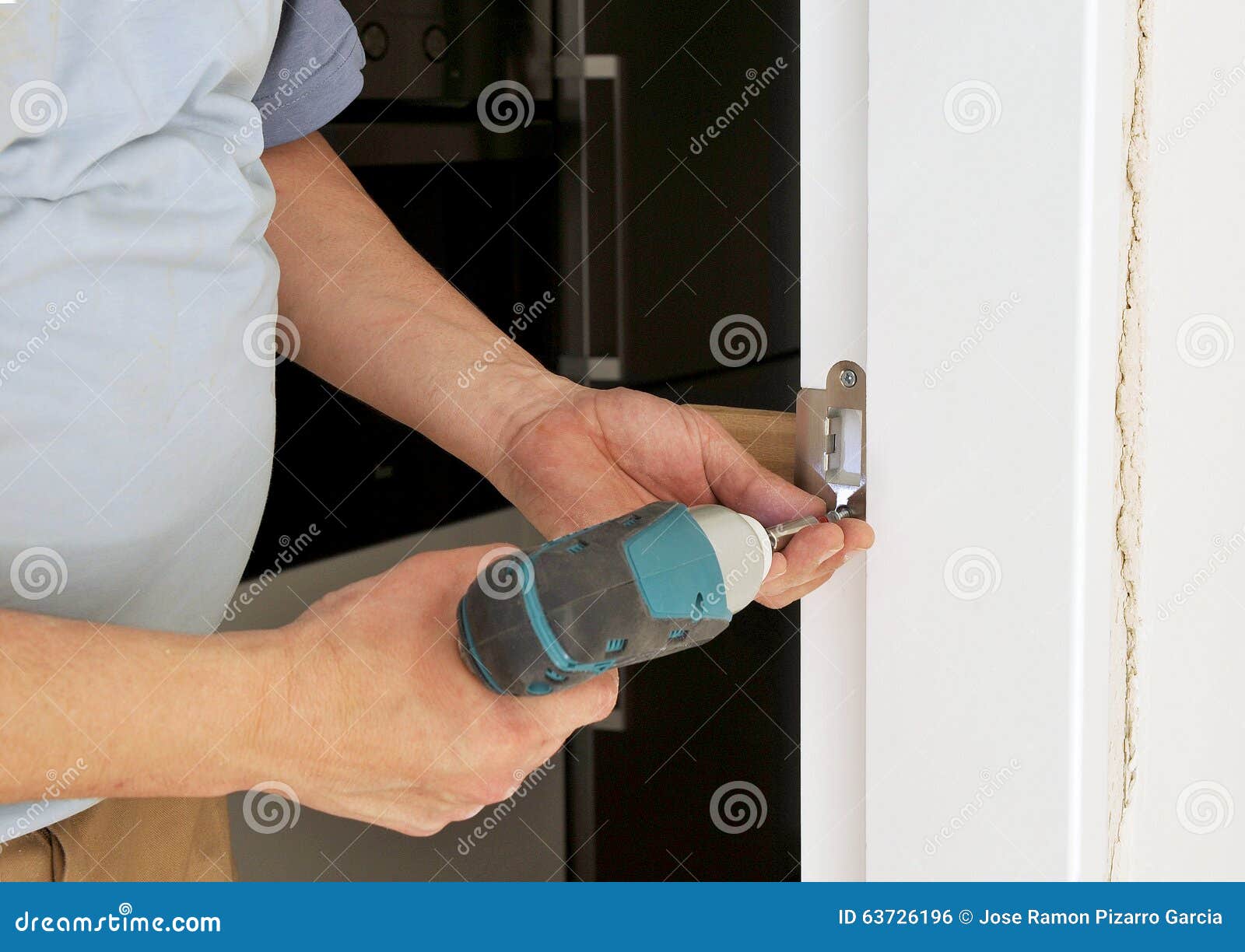 Carpenter Screwing the Latch of a Door Stock Photo - Image of gate ...