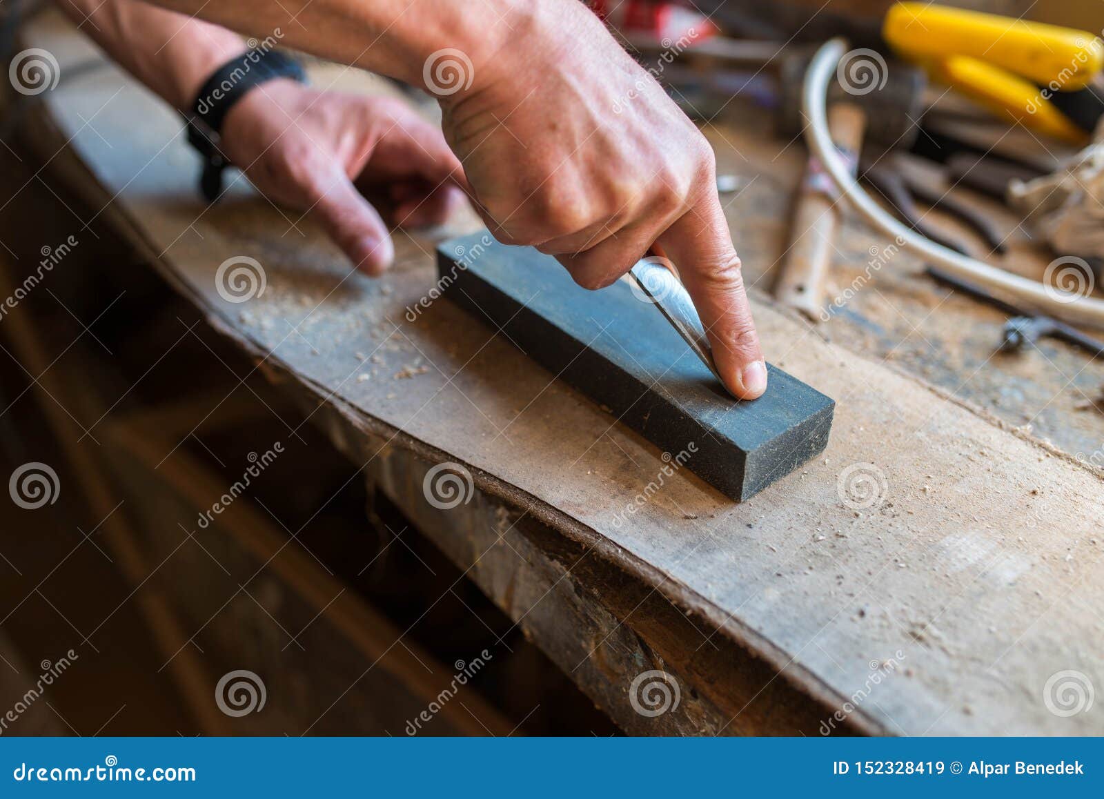Carpenter Sharpening a Chisel in a Small Workshop Stock Image - Image ...