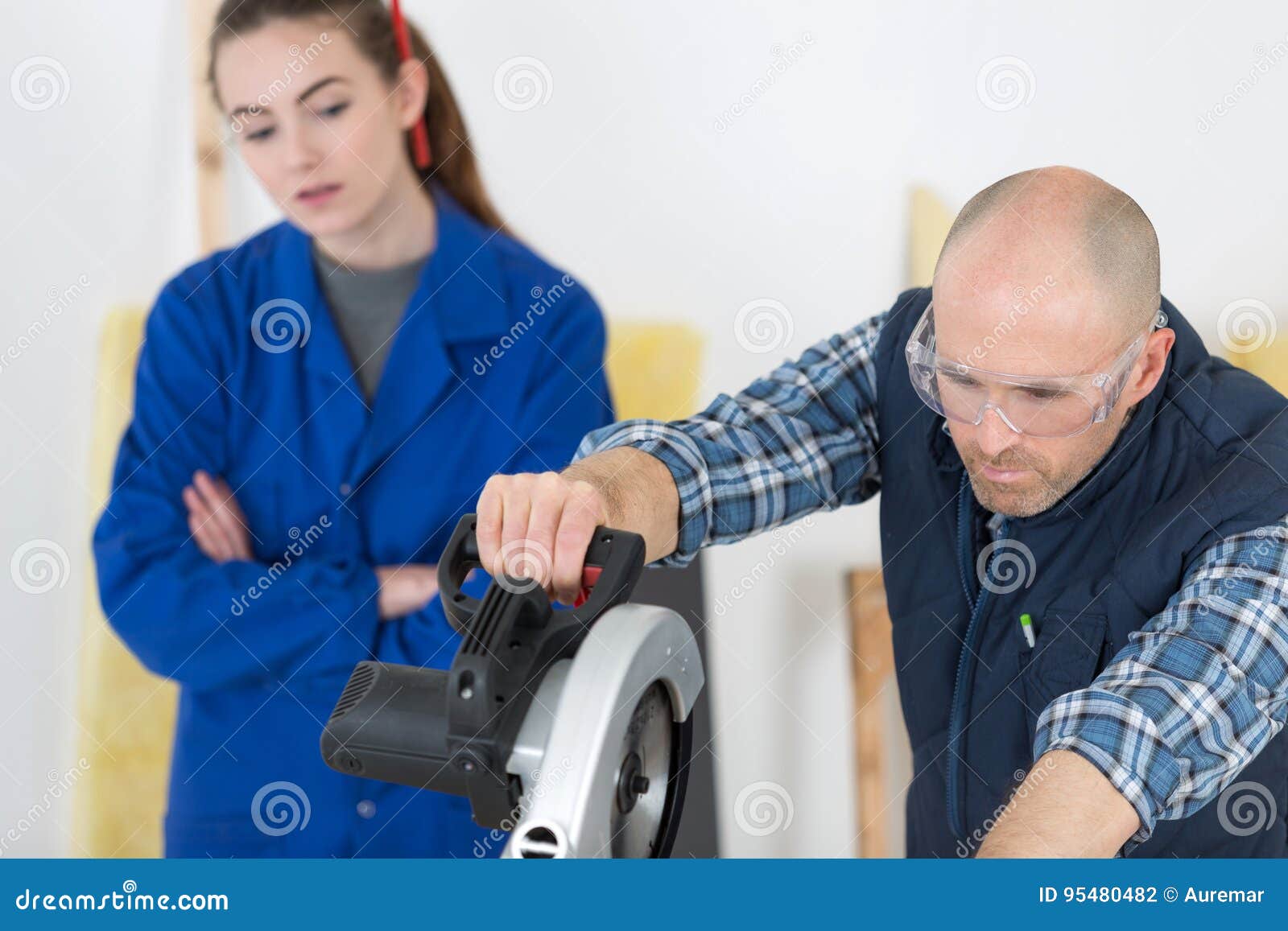 Carpenter Showing Apprentice How To Cut Wooden Plank Stock Photo ...
