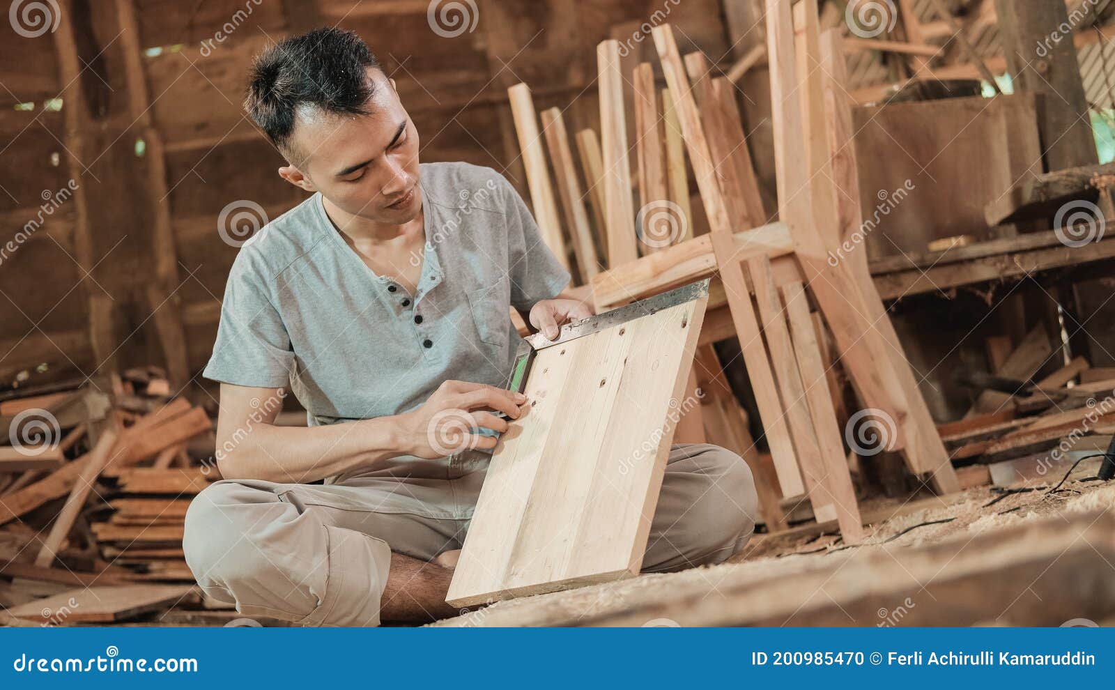 Carpenter Sitting on the Floor Holding a Carpenter Elbow Ruler Stock ...