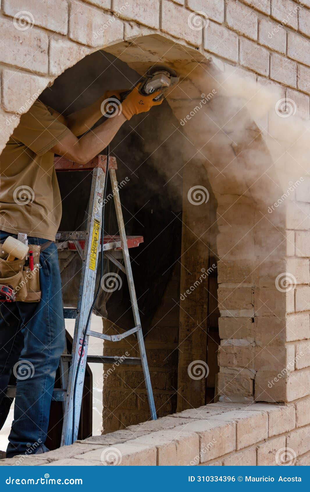 A Carpenter on a Step Ladder Grinding an Adobe Brick Frame To ...